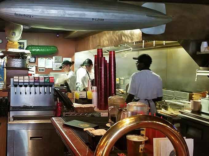 The kitchen crew in action, transforming raw ingredients into the kind of burgers that inspire loyalty and devotion.