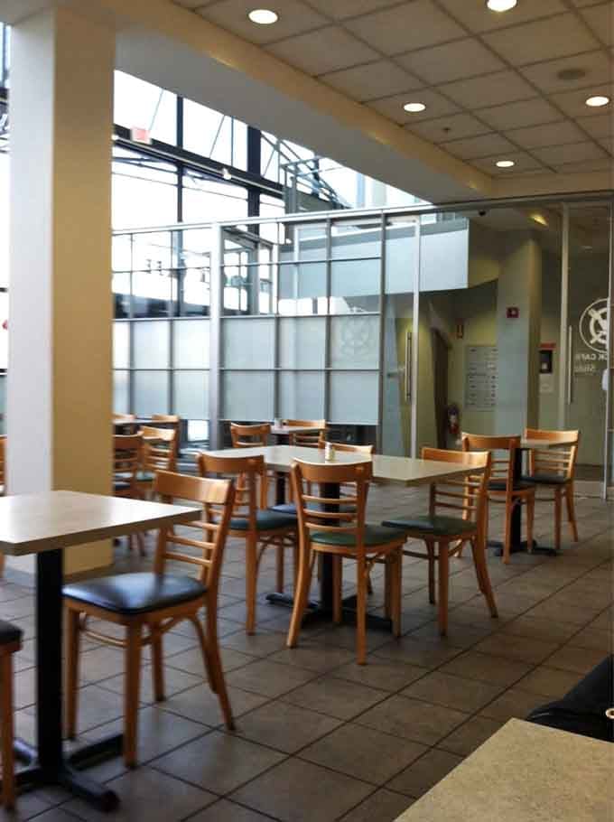 Clean, modern dining space with plenty of natural light streaming through those generous windows overlooking the Seaport.