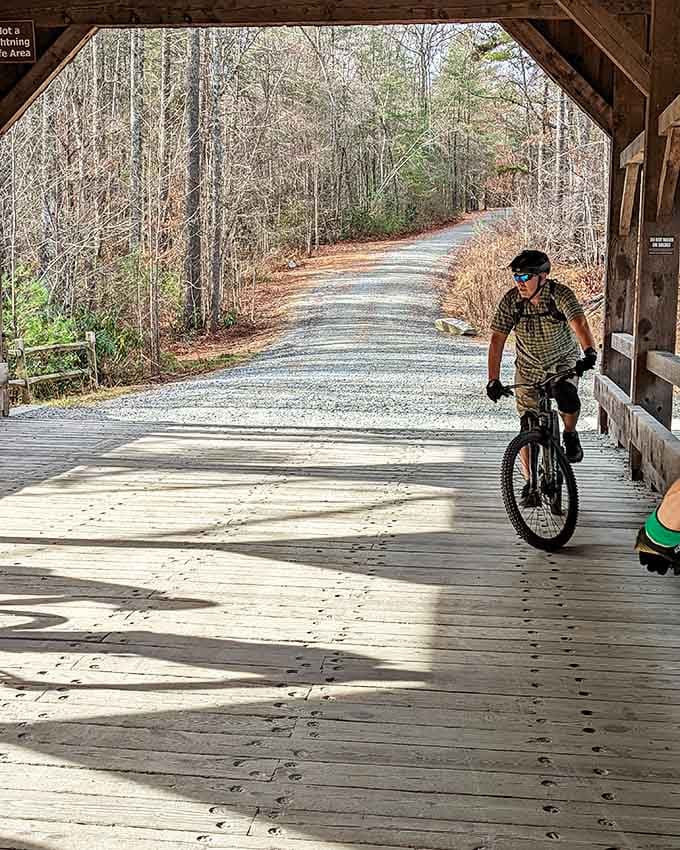 Pedaling through a covered bridge feels like time travel, except you're heading toward waterfalls instead of the general store.
