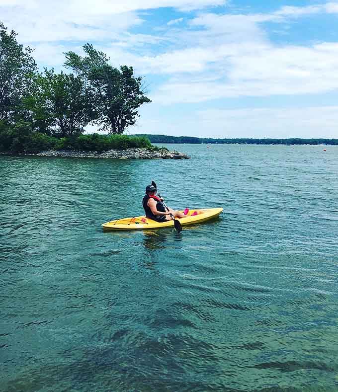 That yellow kayak gliding across turquoise water looks like a postcard someone forgot to mail from vacation.