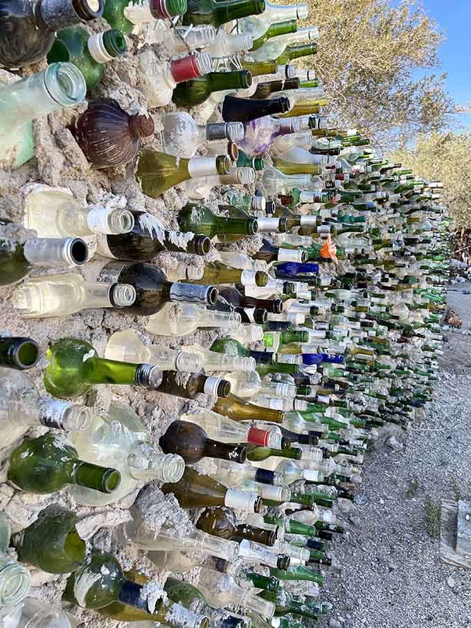Thousands of bottles create a glittering wall that catches sunlight and transforms waste into something oddly beautiful.