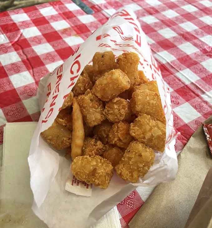 Golden nuggets of potato perfection tumbling out like treasure, each one a crispy little miracle worth celebrating with enthusiasm.