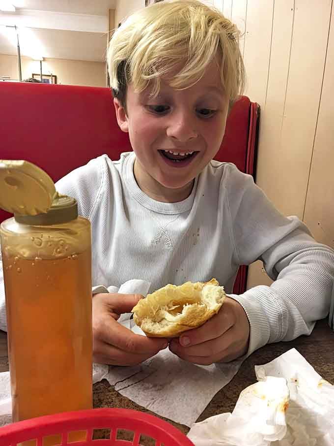 Pure joy captured in a single moment, because good food has a way of making everyone smile like this.