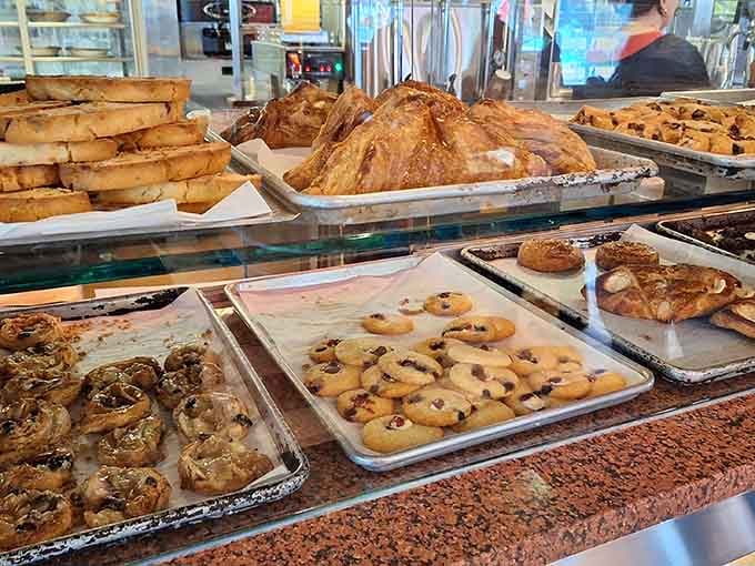 The pastry case displays cookies, croissants, and temptations that make willpower pack its bags and leave town entirely.