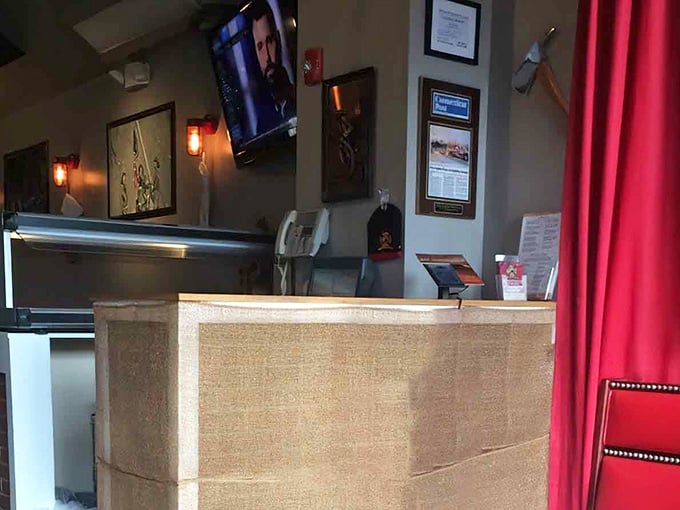 The host stand welcomes you with firefighting memorabilia, setting the tone before you've ordered a single slice.