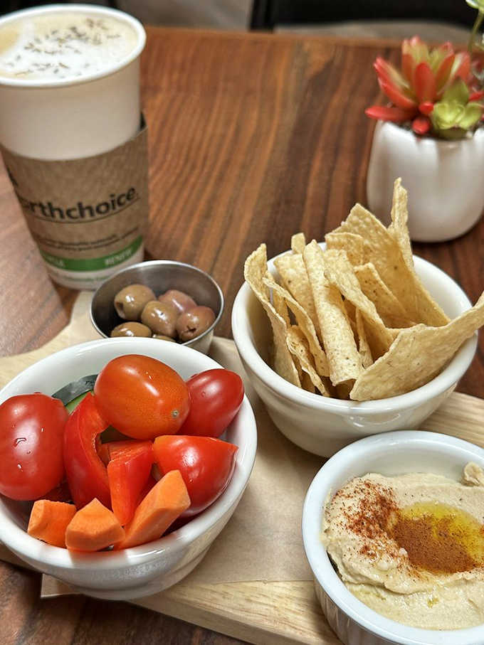 Hummus, veggies, and chips arranged like edible art, perfect fuel for your next chapter or conversation.