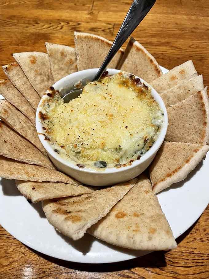 Artichoke spinach dip with pita chips proves that some appetizers deserve their own standing ovation and immediate reorder.