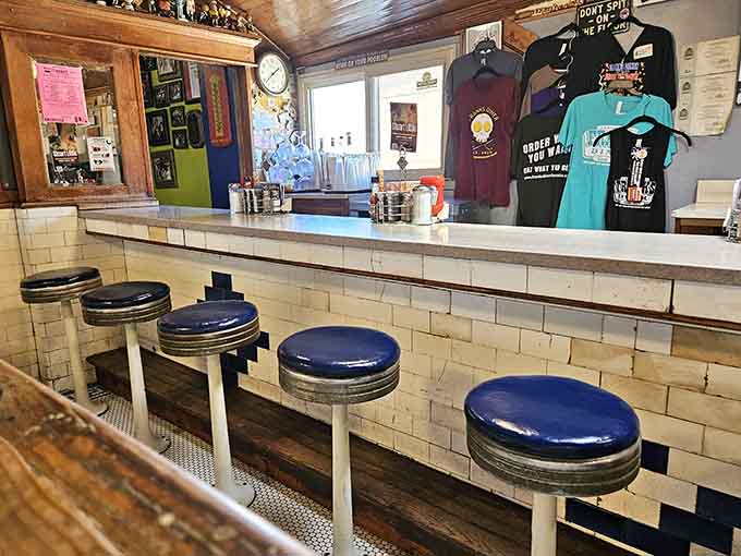 Those classic blue vinyl stools and white tile counter transport you back to when diners were the heart of every community.
