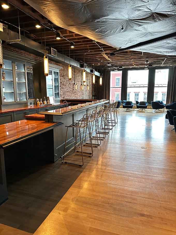 The bourbon tasting hall features gleaming wood floors and exposed brick, blending industrial chic with Kentucky hospitality perfectly.