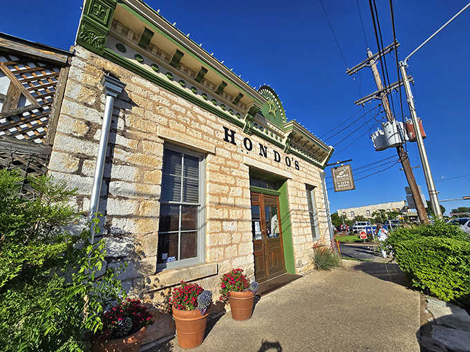 Limestone walls and potted flowers frame this corner spot where authentic character meets genuine Texas hospitality beautifully.