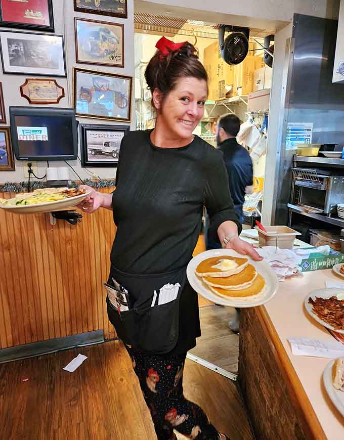 Friendly staff delivering giant pancakes with genuine smiles, because great service never goes out of style.