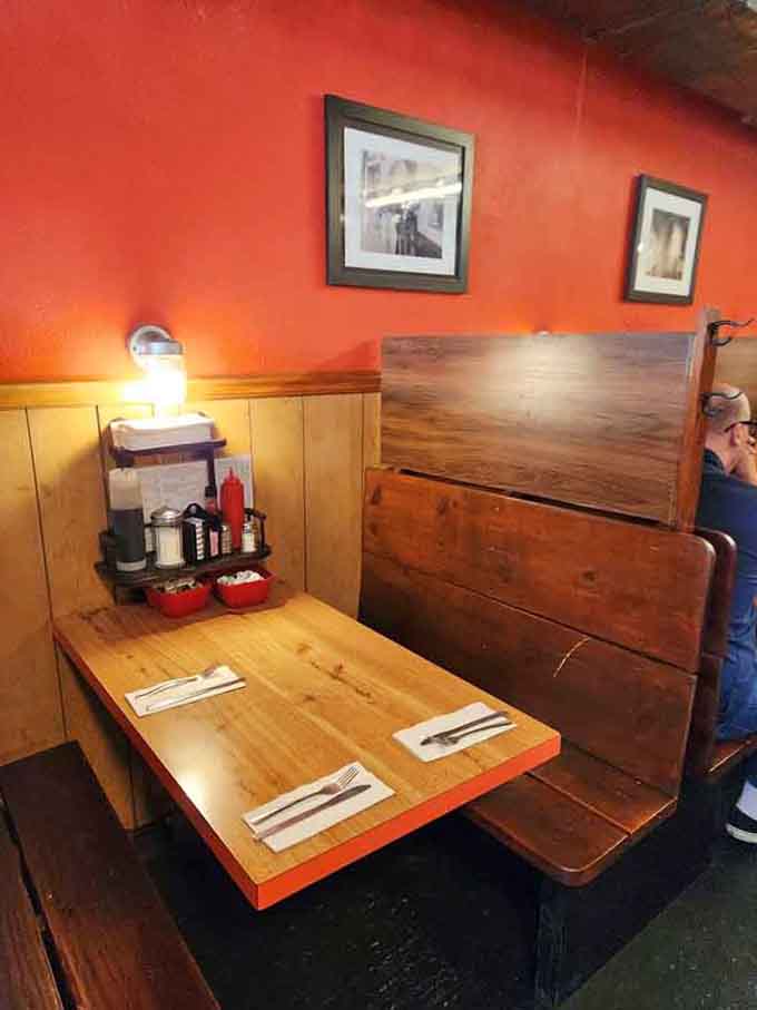 Cozy booth seating with wood tables that have hosted countless conversations over eggs and coffee through the decades.