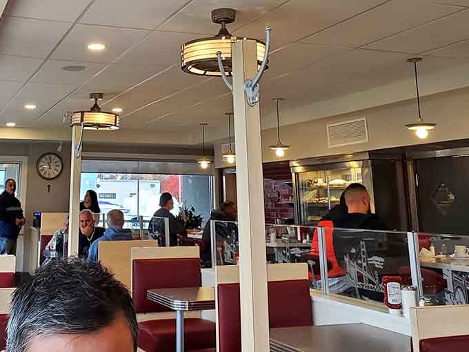 The counter stretches invitingly, offering front-row seats to the culinary theater happening behind the glass partition.