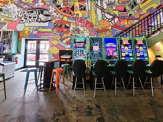 Arcade gaming machines beneath psychedelic murals ensure nobody's checking their phone during dinner, which feels revolutionary these days.
