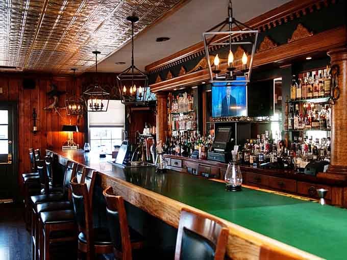 The classic tavern bar with its green felt rail invites you to settle in for a proper drink.