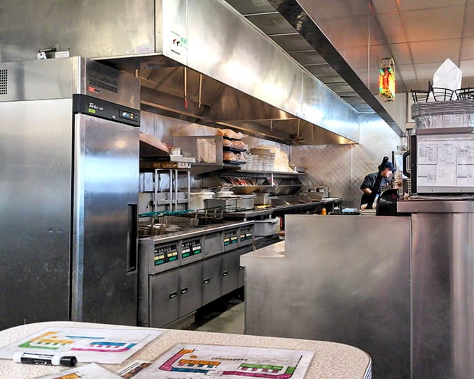 Behind the scenes, the kitchen gleams with efficiency, ready to crank out comfort food with assembly-line precision and care.