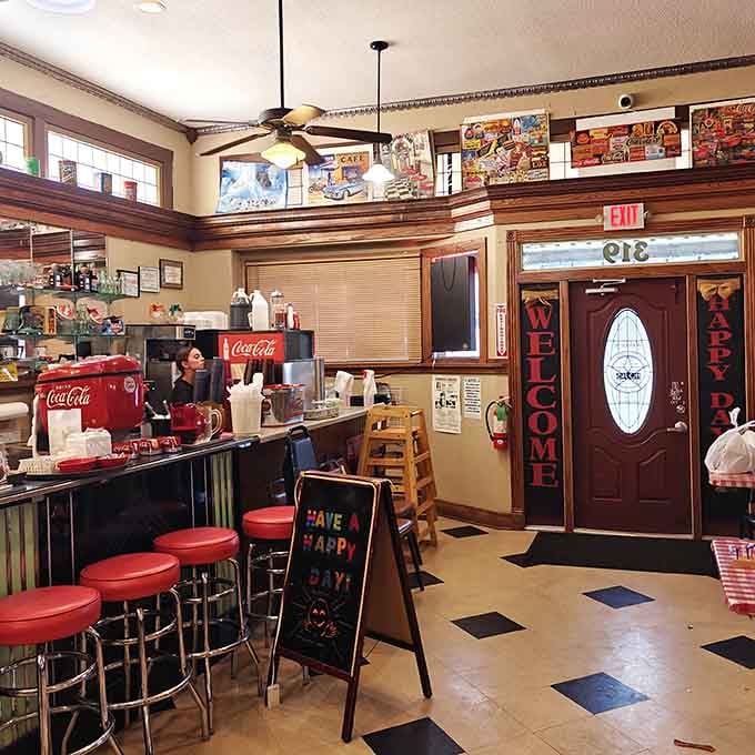 Red vinyl counter stools and vintage Coca-Cola coolers invite you to sit, relax, and enjoy the show.