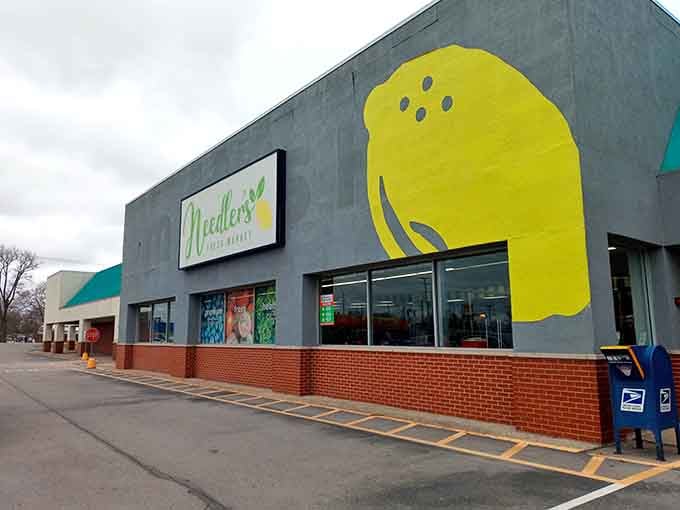 Needler's cheerful yellow bowling pin logo promising fresh groceries and hometown service that big chains forgot how to deliver.
