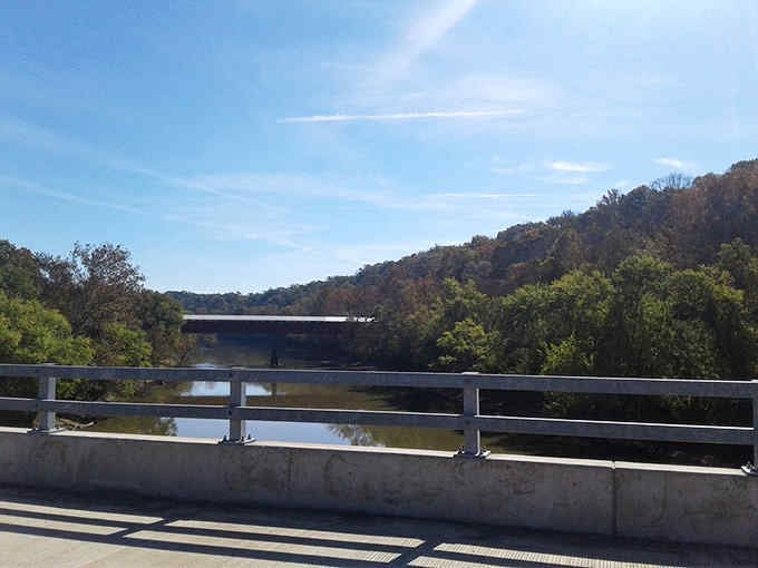 That modern concrete bridge in the distance makes you appreciate the craftsmanship of the covered version even more.