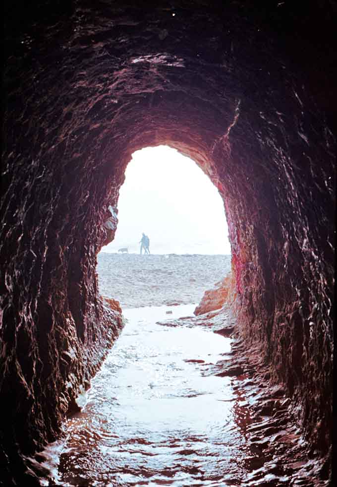 Looking out from inside the cave feels like peeking through a portal to another, more magical world.