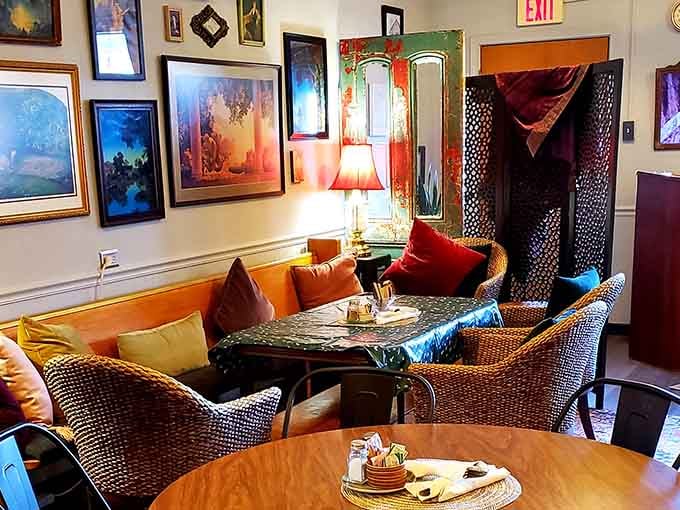 Orange velvet seating and gallery walls create cozy corners where mimosas taste like they're meant to be savored slowly.