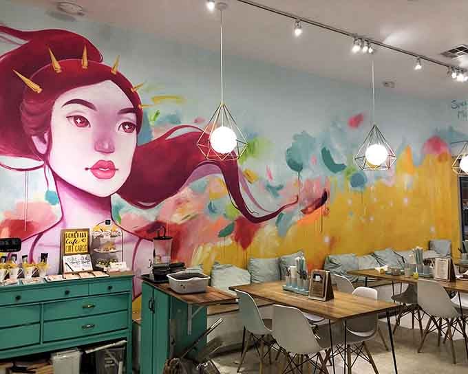 That vibrant portrait watches over creative souls as they sip lattes and unleash their inner Picasso below.