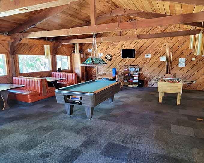 Game room with pool table, foosball, and cozy seating&mdash;rainy day entertainment sorted and then some.