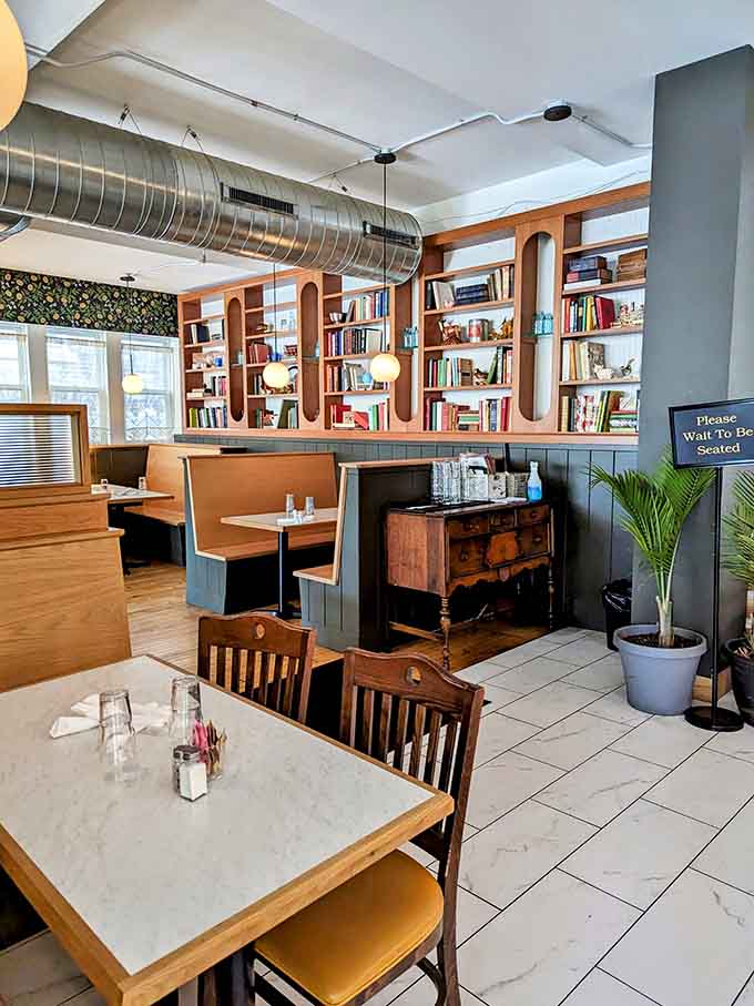 Built-in bookshelves and cozy booths create that rare restaurant space where lingering feels encouraged, not rushed.