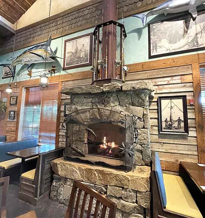 The stone fireplace adds rustic warmth to balance all that cool blue aquatic energy flowing through the dining room.