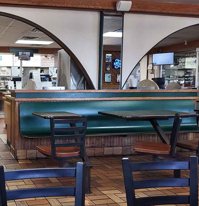 Teal booths and wood paneling creating that timeless diner vibe where everyone feels like a regular customer.