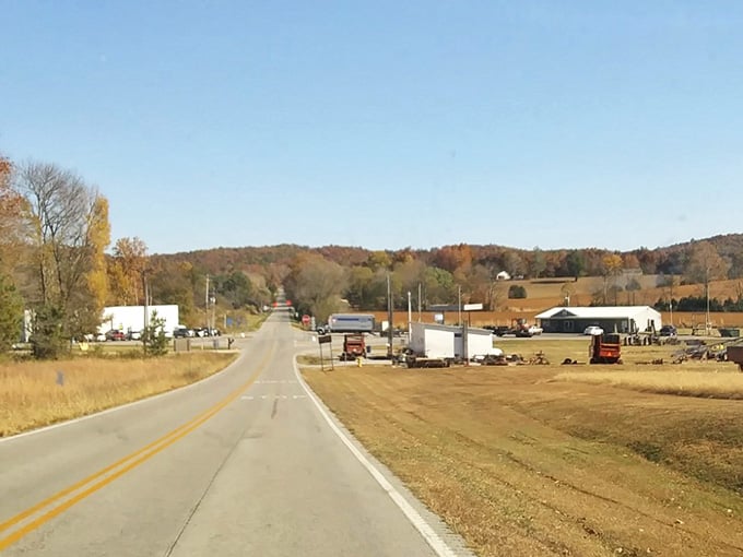 Open roads and autumn hills await beyond this simple highway marker in rural Kentucky countryside.