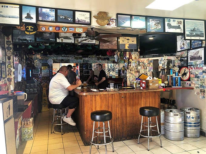 The bar where Maverick sang still welcomes visitors, now covered in memories and military pride from decades.