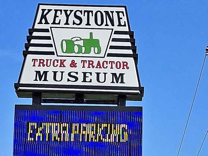 The roadside sign announces this unique destination where breakfast and tractors coexist in unexpected harmony for curious travelers passing through.