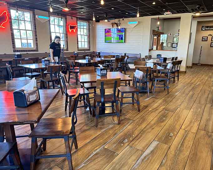 Spacious dining room with wooden floors where strangers bond over brisket and become temporary best friends through shared joy.