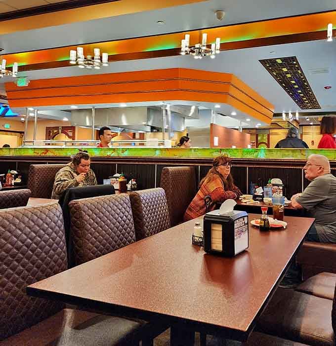 Fellow diners enjoying their meals in comfortable booths, each on their own personal quest for buffet glory today.