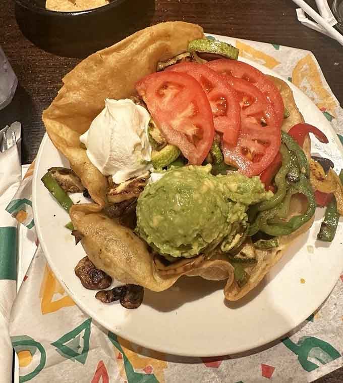 This towering taco salad in a crispy shell is basically a delicious edible bowl of happiness and vegetables.