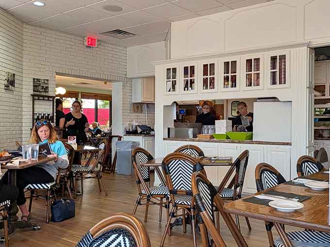 Classic French café seating invites lingering conversations over croissants, because rushing through pastries should be illegal.