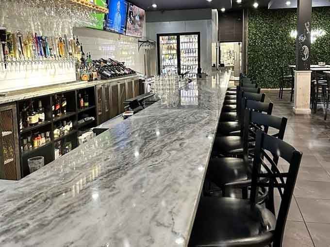 The sleek marble bar with an impressive tap selection proves that great seafood deserves equally impressive beverage pairings nearby.