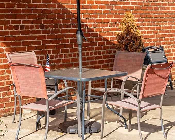Even the outdoor patio seating against that gorgeous brick wall invites you to linger over conversation and tea.