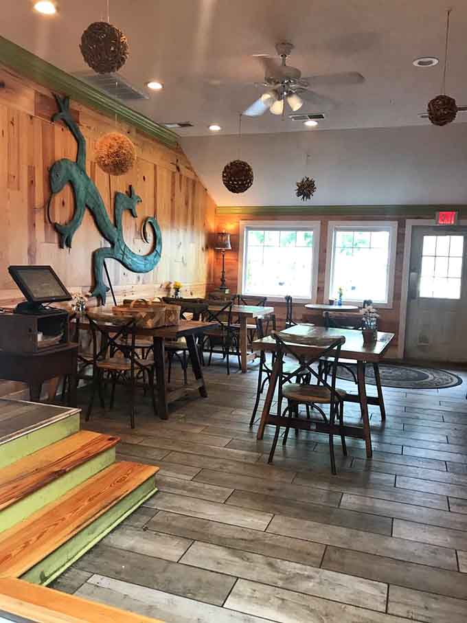 Rustic wooden tables and artistic lizard sculptures create an atmosphere that's equal parts beachy and bohemian chic.