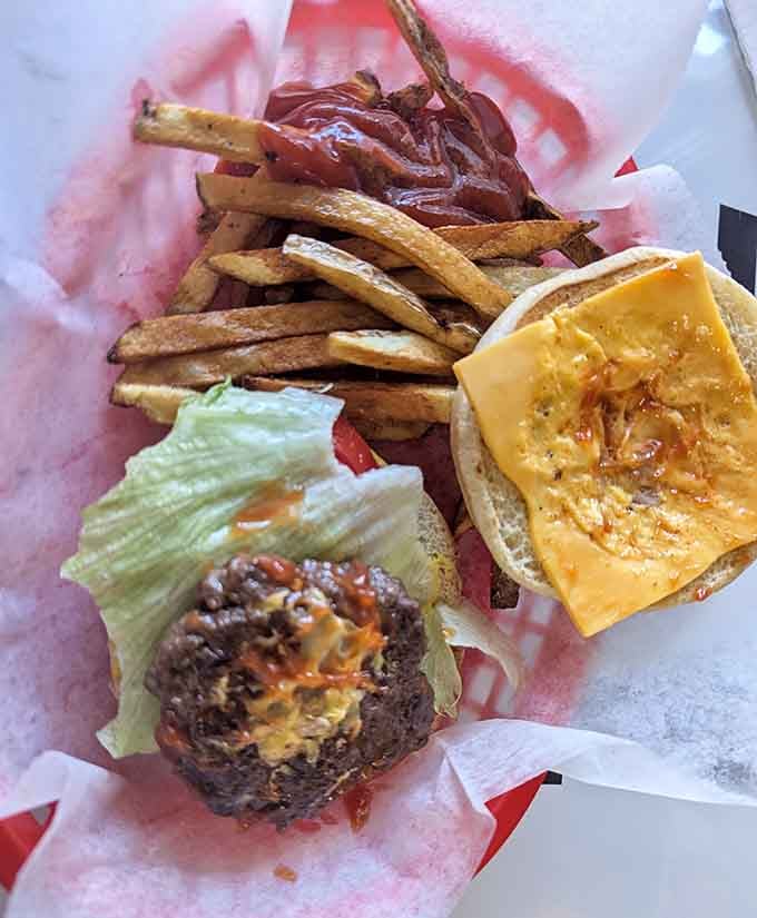 Two patties, melted cheese, crispy fries, and a recipe older than your grandparents' wedding photos combined perfectly here.