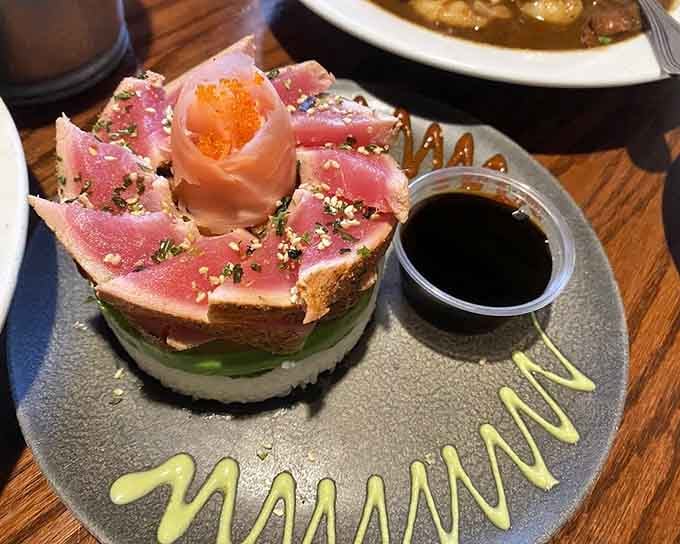 Seared ahi tuna arranged like edible architecture, proving beach restaurants can deliver sophistication when they want to.