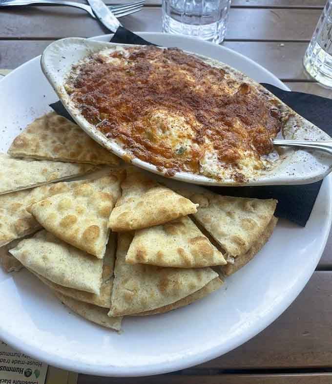 That bubbling hot dip surrounded by crispy pita chips is calling your name louder than your diet ever could.