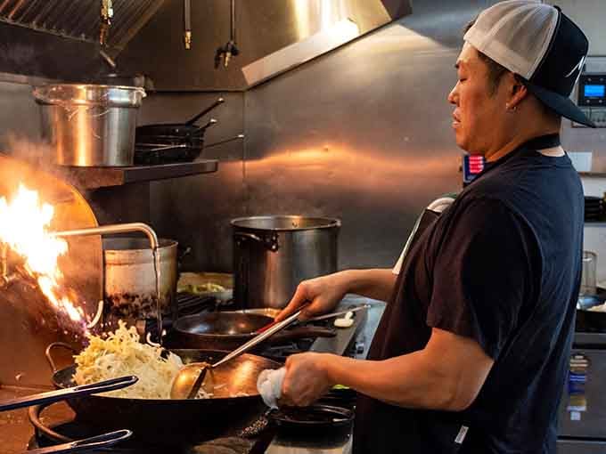 The kitchen in action, where flames fly and skilled hands transform simple ingredients into craveable Korean-inspired magic.