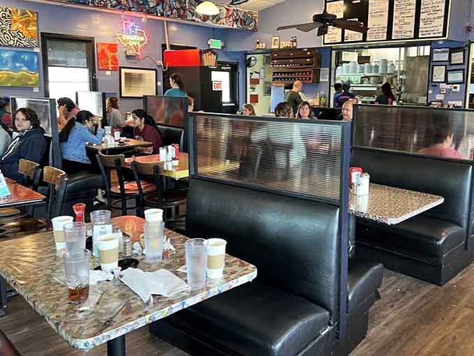 Black vinyl booths and speckled tables: classic diner seating that's hosted countless conversations, confessions, and celebrations over the decades.