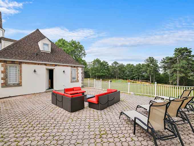 Wrap-around deck seating overlooks the grounds where you can survey your domain with morning coffee in hand.