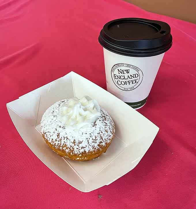New England Coffee pairs perfectly with powdered sugar bliss, creating the breakfast combination that makes mornings almost tolerable again.