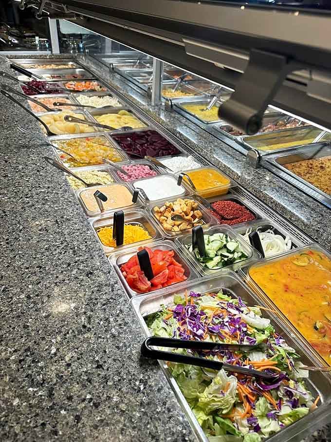 This salad bar stretches on like a colorful promise of fresh options and endless possibilities.