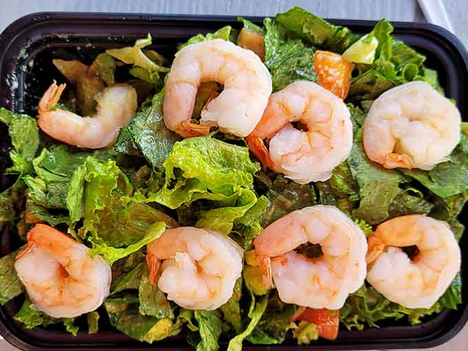 Fresh shrimp perched on greens like they're posing for their best angle in a food magazine.