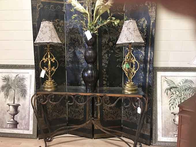 Ornate metalwork and matching lamps create an entrance vignette that screams sophisticated elegance and timeless taste.